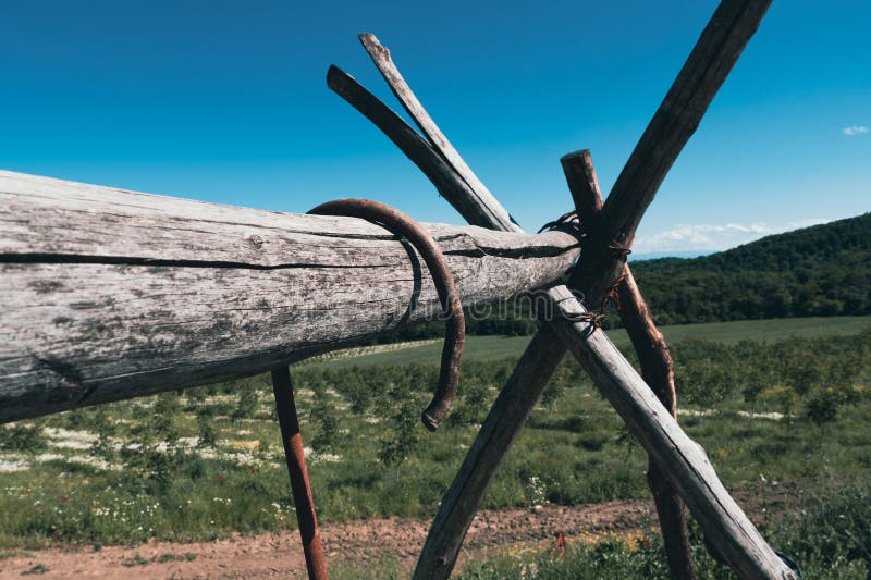 Rusty hook on wooden beams stock photo. Image of element - 324211684
