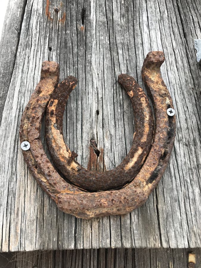 Rusty Horseshoes on a Burned Wooden Pole - Rustic Scene in a Country ...