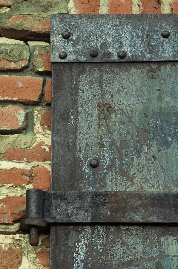 Rusty iron door on brick stock photo. Image of pivot - 89410796