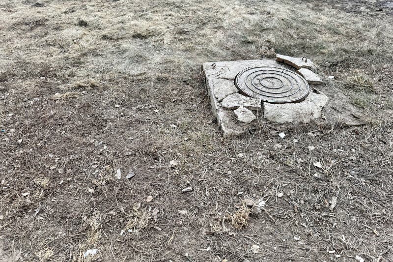 A Rusty Iron Hatch with a Pattern and a Large Gap at the Top is Mounted ...
