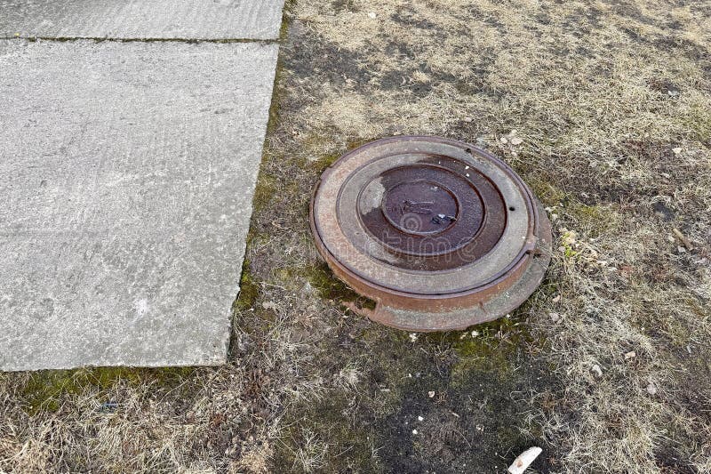 A Rusty Iron Hatch with a Pattern is Located Next To a Dry Grass ...