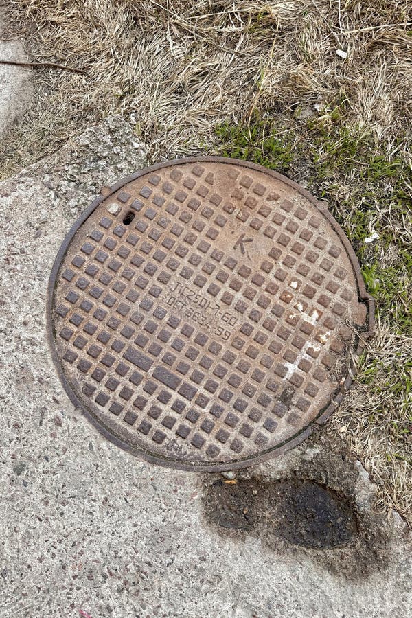 A Rusty Iron Hatch with a Pattern is Mounted in the Asphalt Pavement of ...