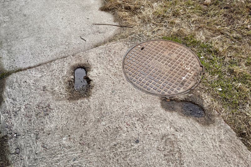 A Rusty Iron Hatch with a Pattern is Mounted in the Asphalt Pavement of ...