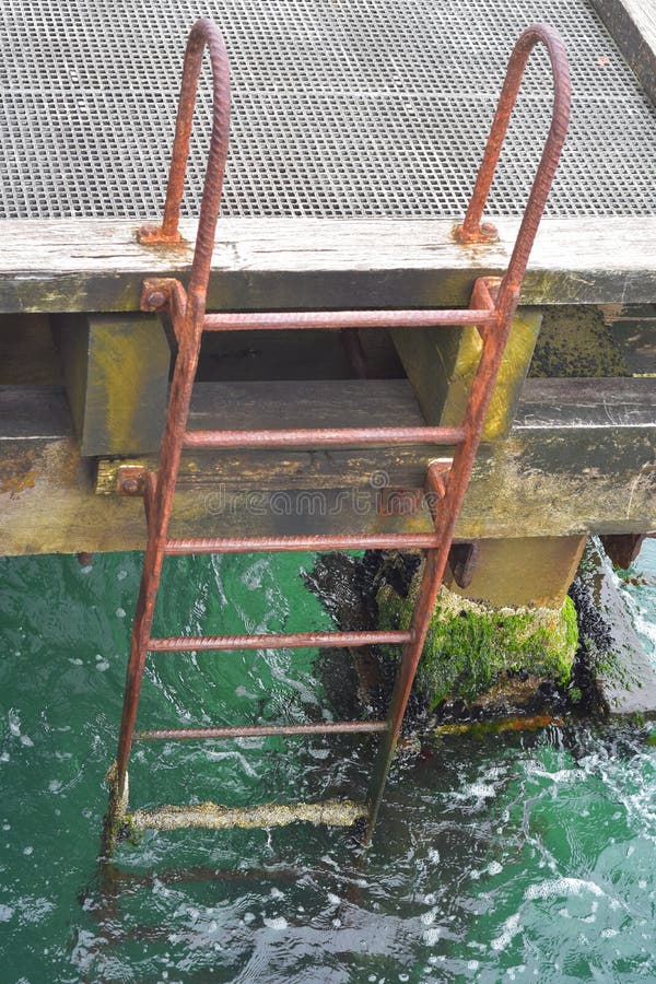 Rusty iron ladder on pier stock photo. Image of pier - 146785102