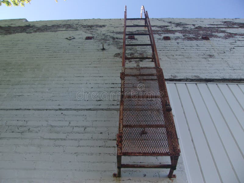 A Rusty Ladder on Side of Building 1 Stock Image - Image of light ...