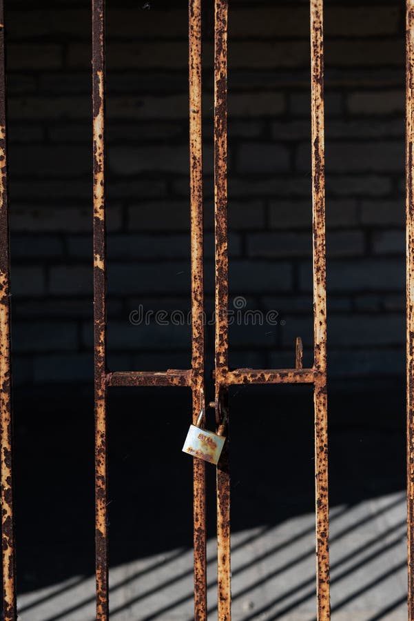 Rusty lock on barred gate stock photo. Image of gated - 156796384
