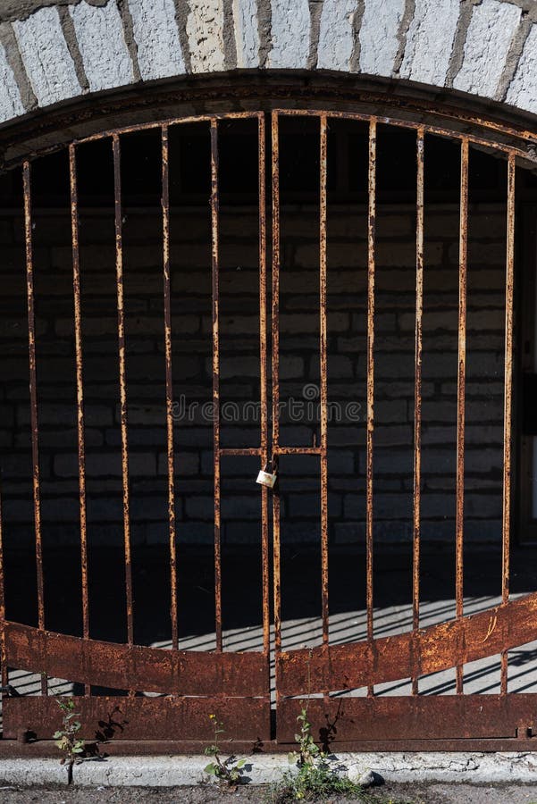 Rusty lock on barred gate stock photo. Image of fence - 156796492
