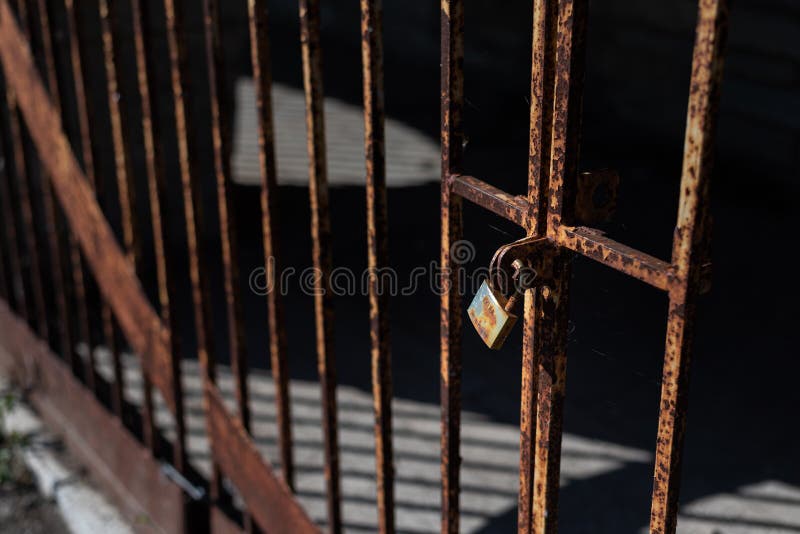 Rusty lock on barred gate stock photo. Image of lock - 156796580