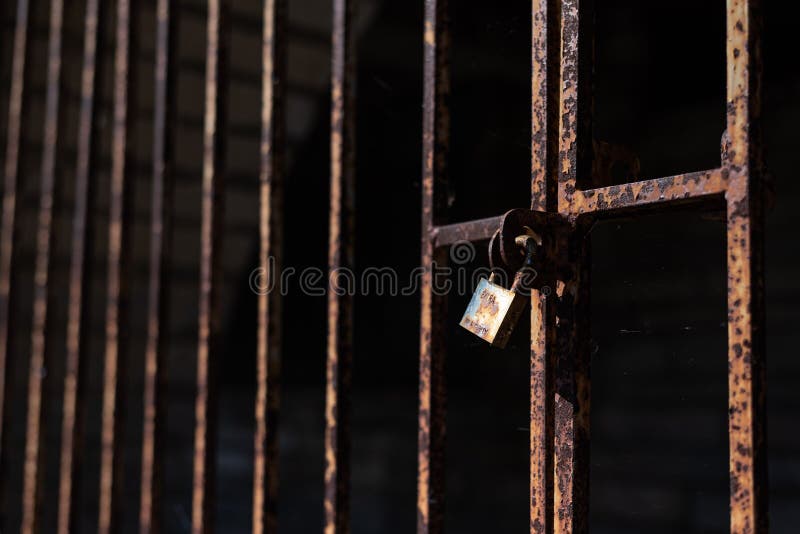Rusty lock on barred gate stock photo. Image of chain - 156796632