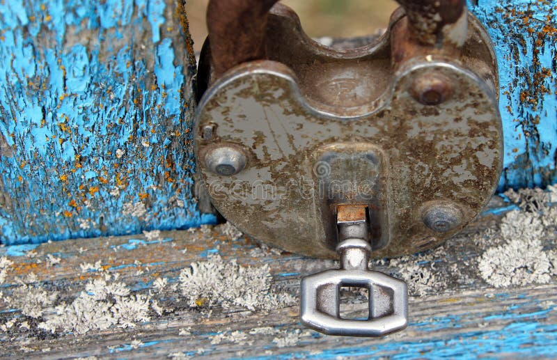 Rusty Lock with a Key on a Blue Wooden Door Stock Image - Image of grey ...