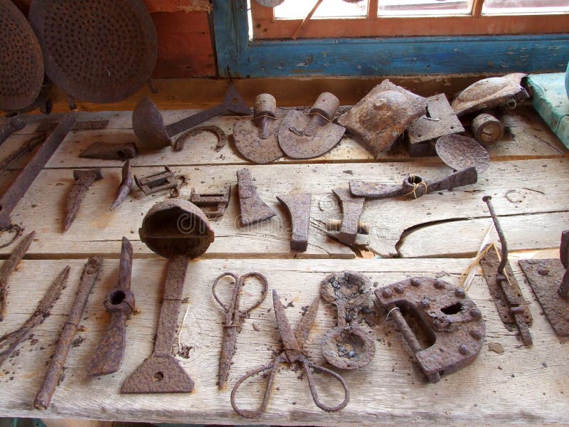 An Assortment of Rusty Items Sitting on a Wooden Table Stock Image ...