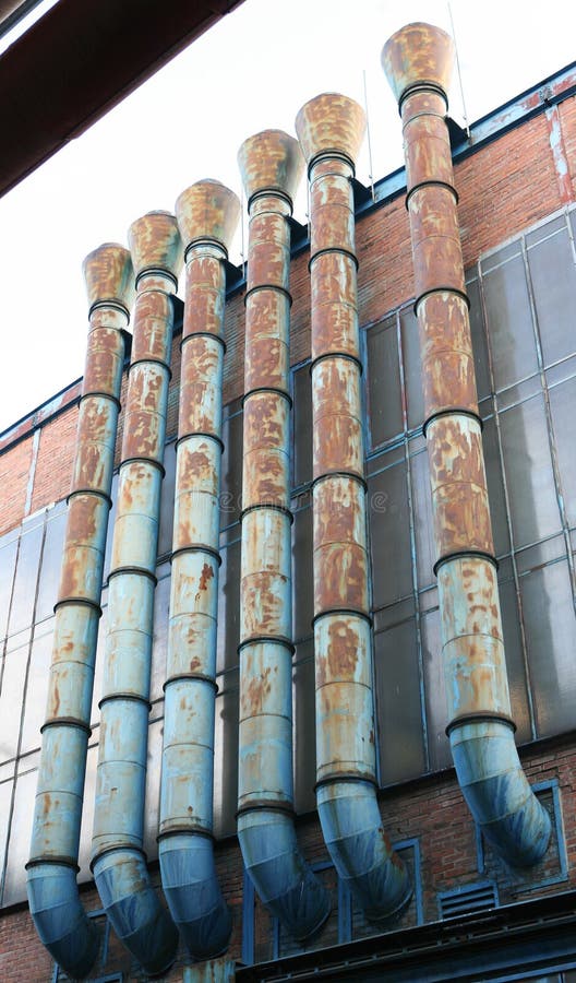Two Metal Chimneys on the Roofs of Factory. Against Blue Sky Stock ...