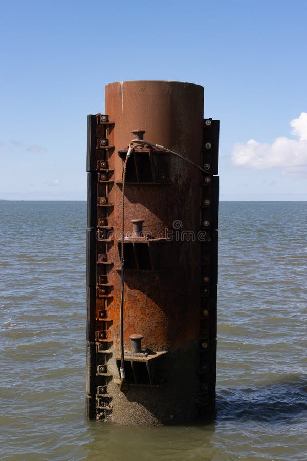 Rusty Metal Dolphin or Mooring Post in a Harbor Stock Image - Image of ...