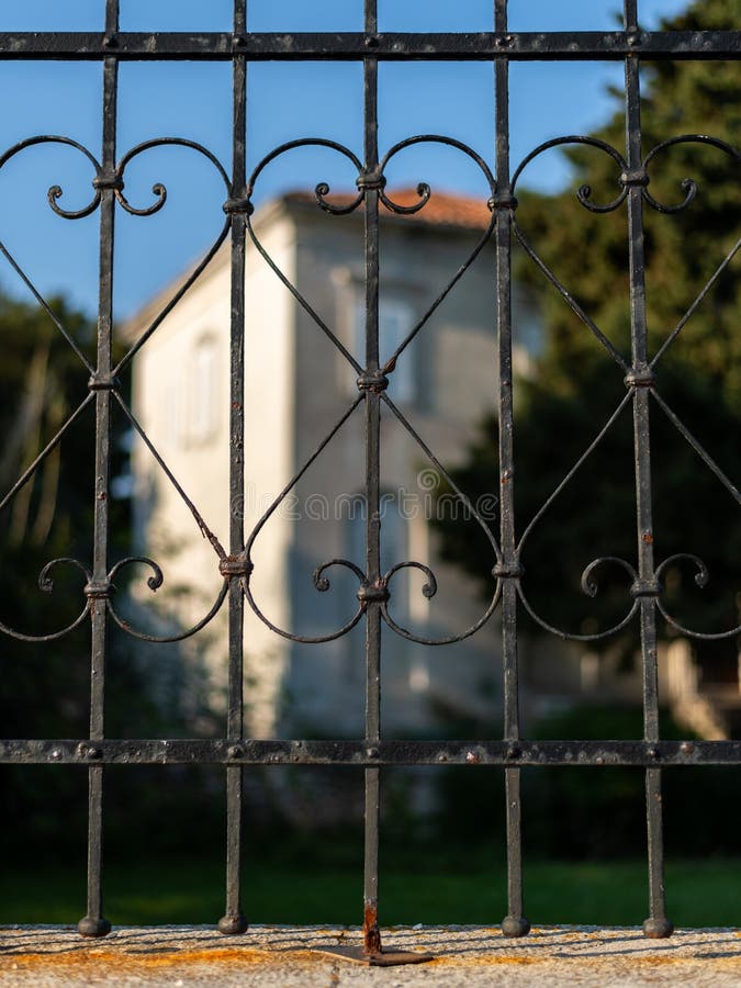 Rusty Metal Gate and a Big House in the Evening Sun Stock Photo - Image ...