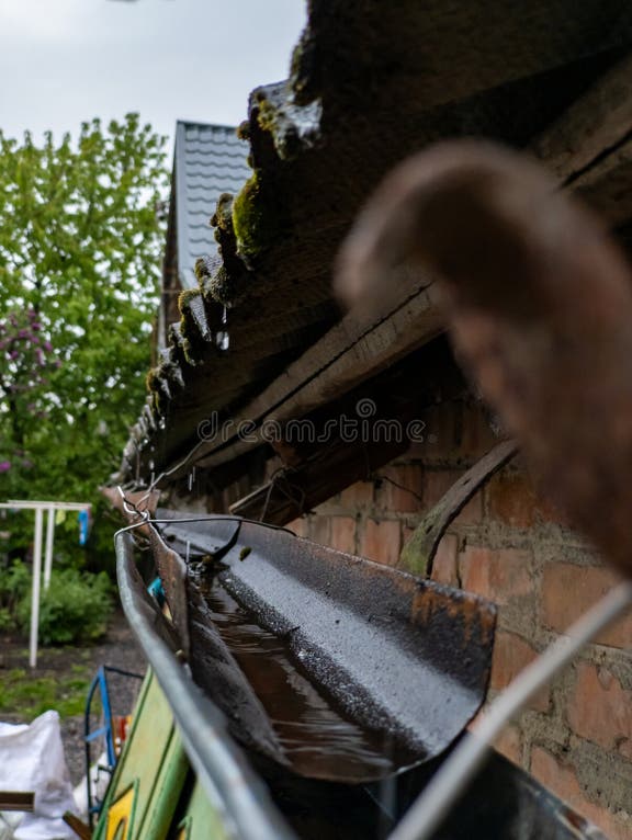 A Rusty Metal Gutter on the Side of a Brick Building Stock Image ...