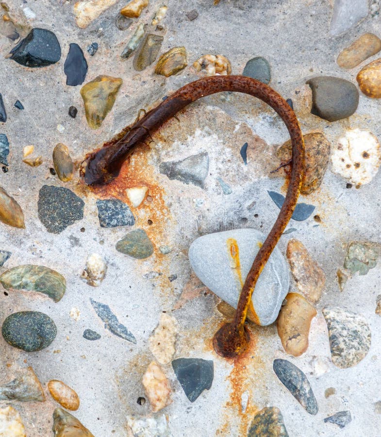 A Rusty Metal Object is Laying on a Rocky Surface Stock Image - Image ...