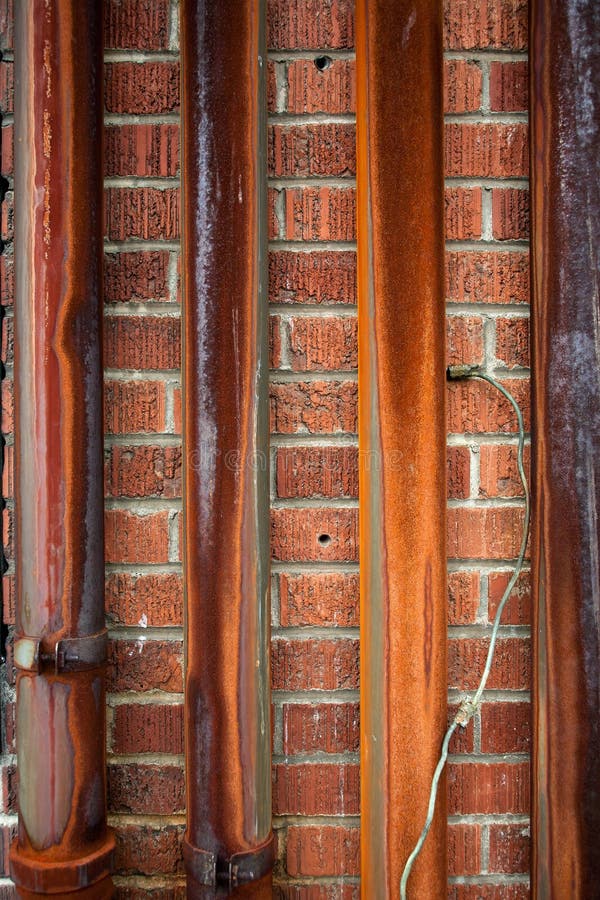 Rusty Metal Pipe on Red Brick Wall Stock Image - Image of texture, wall ...