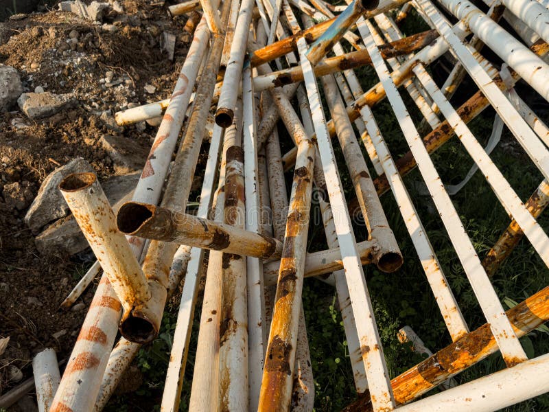 Rusty Metal Pipes on Ground with Grid Frame Structure Stock Photo ...