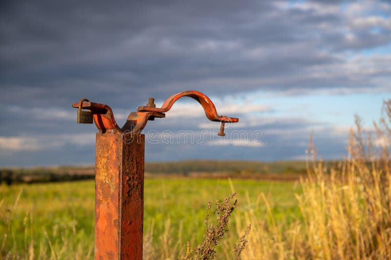 Rusty Metal Post on a Field for a Barrier Stock Photo - Image of rusty ...