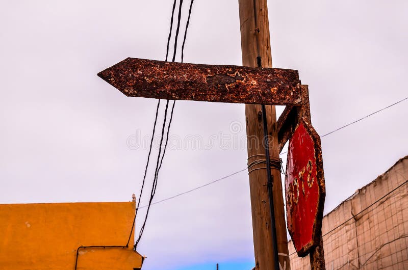 A Rusty Metal Sign with a Red Arrow Pointing To the Right Stock Image ...