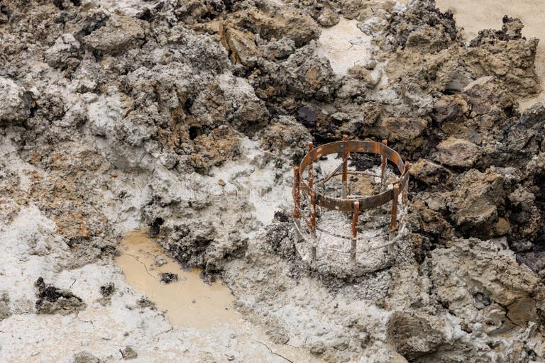 Rusty Metal Structure on Rocky Terrain with Muddy Water Stock Image ...