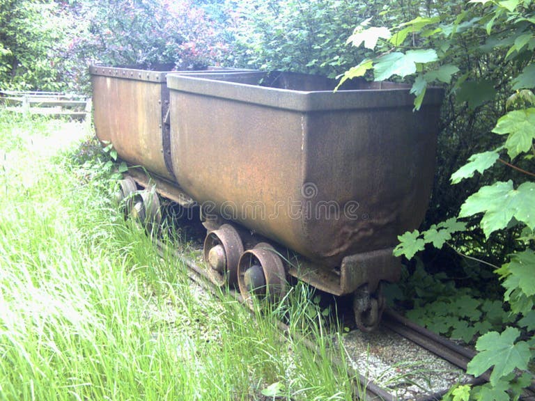 Rusty mining train carts stock image. Image of railing - 348429563