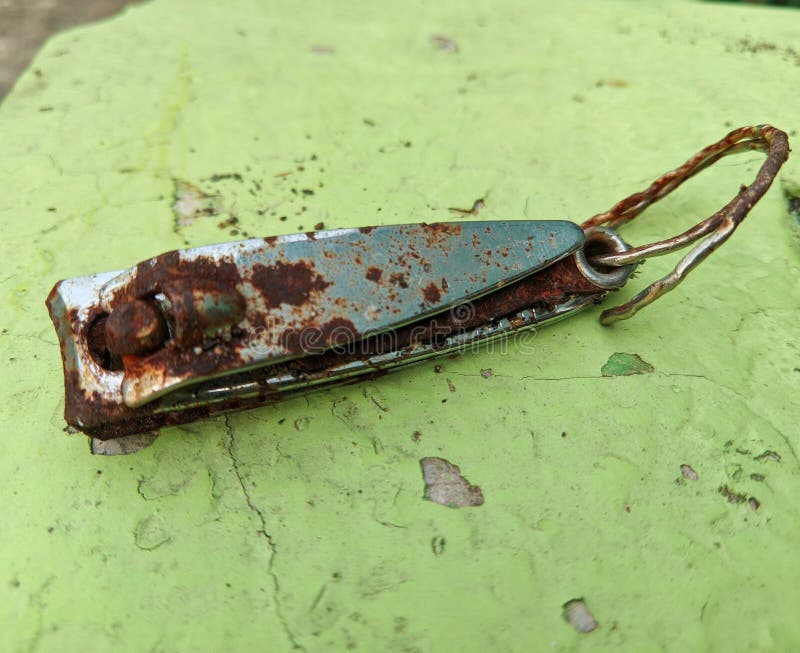 Rusty Nail Clippers on Peeling Green Walls Stock Photo - Image of nail ...