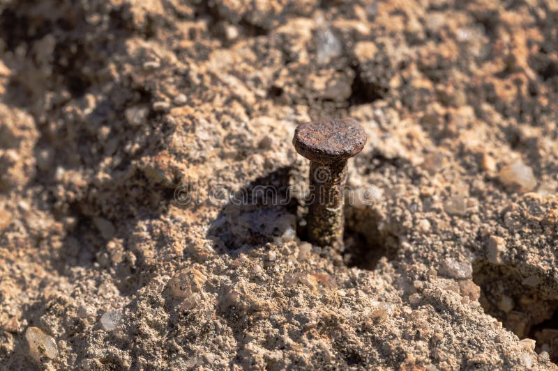 A Rusty Nail or Spike Driven into a Rock. Horizontal Stock Photo ...