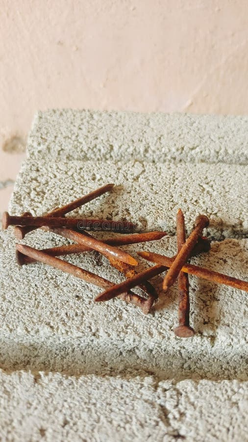 Rusty Nails on Cement Bricks Wall Stock Image - Image of leaf ...