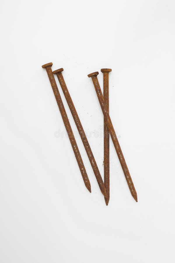 Group of Four Long Rusty Nails Against Plain White Background Stock ...