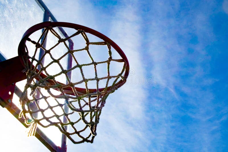 A Rusty Old Basketball Hoop Against a Blue Sky in the Evening Stock ...