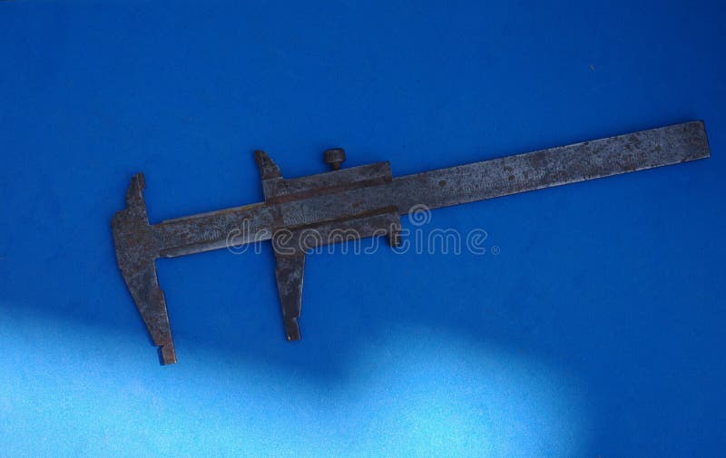 Rusty Old Caliper on a Blue Background. Device for Reading Out a ...
