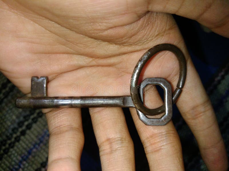 Rusty old key hold by hand stock image. Image of rusty - 155279451