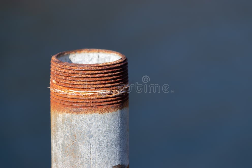 Rusty Old Pipe Sticking Out the Side of a Board Walk Stock Image ...