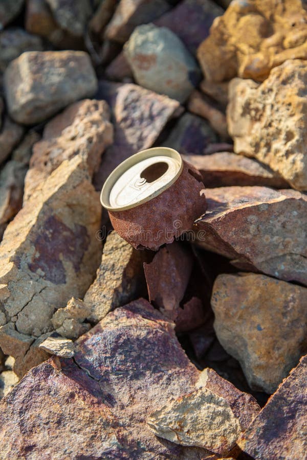 Rusty Old Tin Can is Located between the Stones on the Ground Surface ...