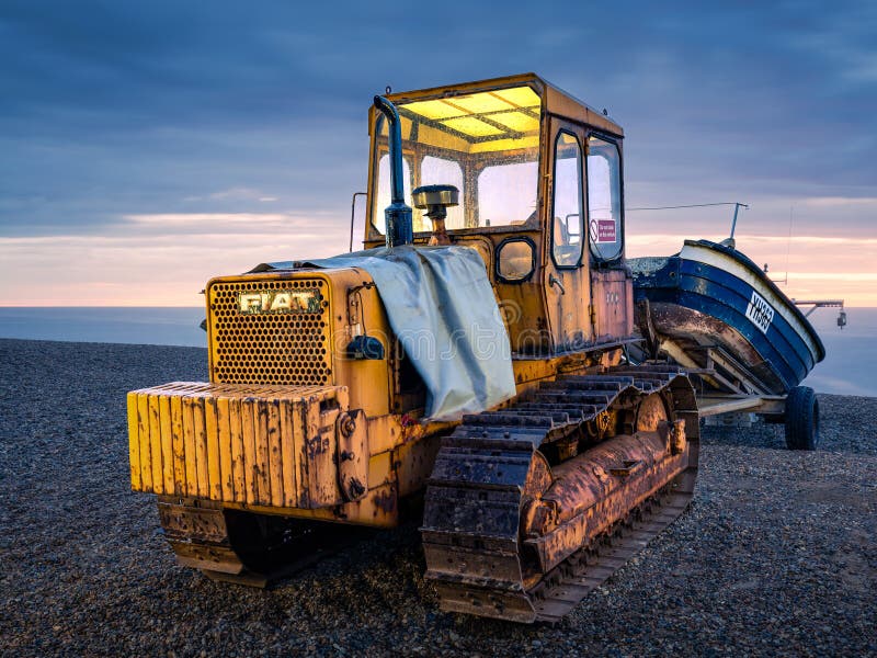 Rusty Old Tractor Towing Fishing Boat on the Beach Stock Image - Image ...