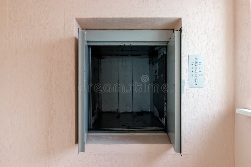 A Rusty Old Transport Elevator in the Wall is Opened Stock Photo ...
