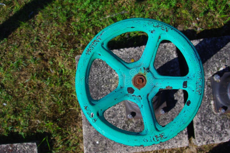 Rusty Old Turquoise Wheel at an Industrial Site Stock Image - Image of ...