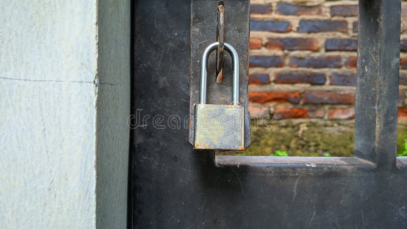 A Rusty Padlock on a Black Iron Gate Stock Image - Image of dirty ...