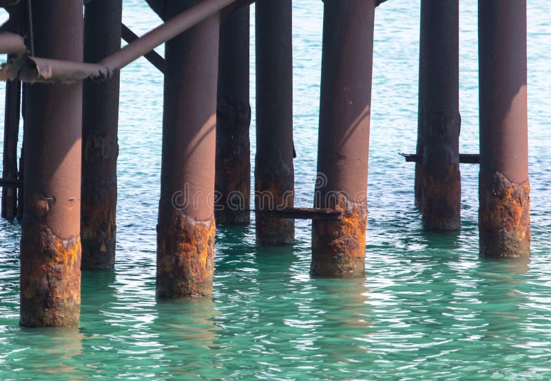 Rusty piles in the water stock photo. Image of rusty - 228952172