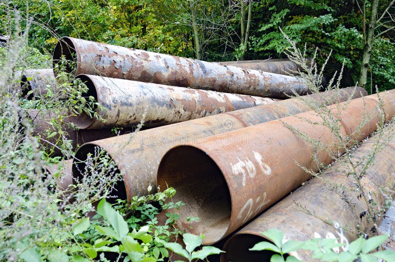 Rusty pipes in a forest stock image. Image of waste, undergrowth - 92699033