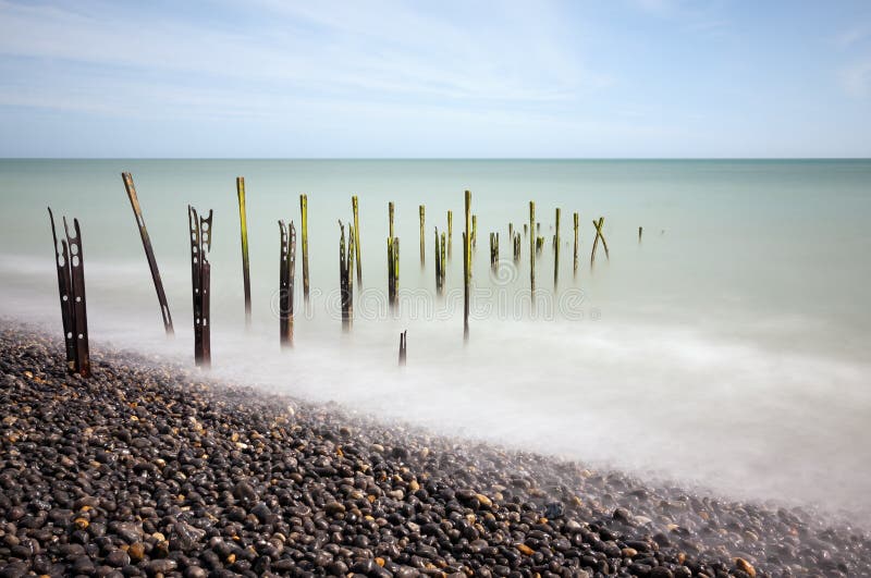 Posts on beach stock image. Image of line, defence, beach - 50757849