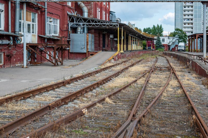 Rusty Rails Going through an Abandoned Industrial Zone Stock Photo ...