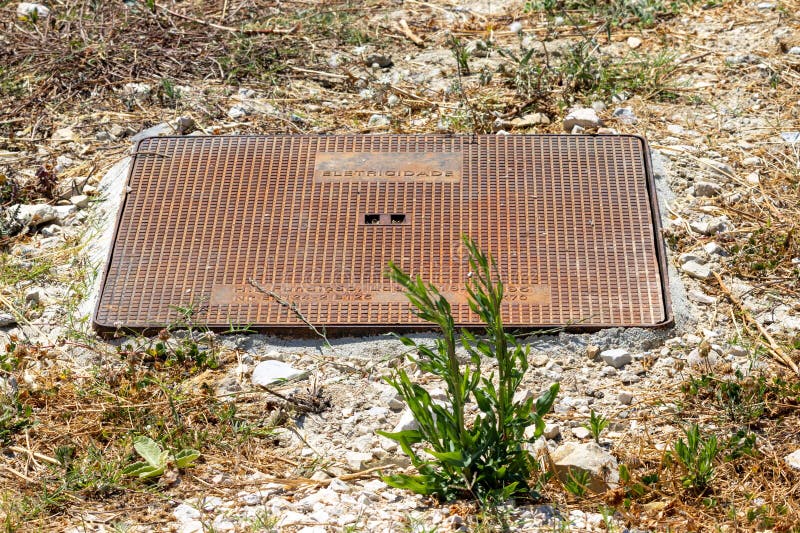 Rusty Rectangular Manhole Cover for Electricity in the Ground Editorial ...