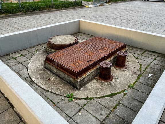 Rusty Weathered Urban Manhole Covers and Smaller Access Caps Set in ...