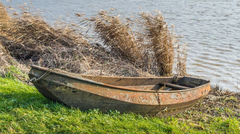 Rusty Rowing Boat at the Bank of a Lake Stock Photo - Image of peace ...