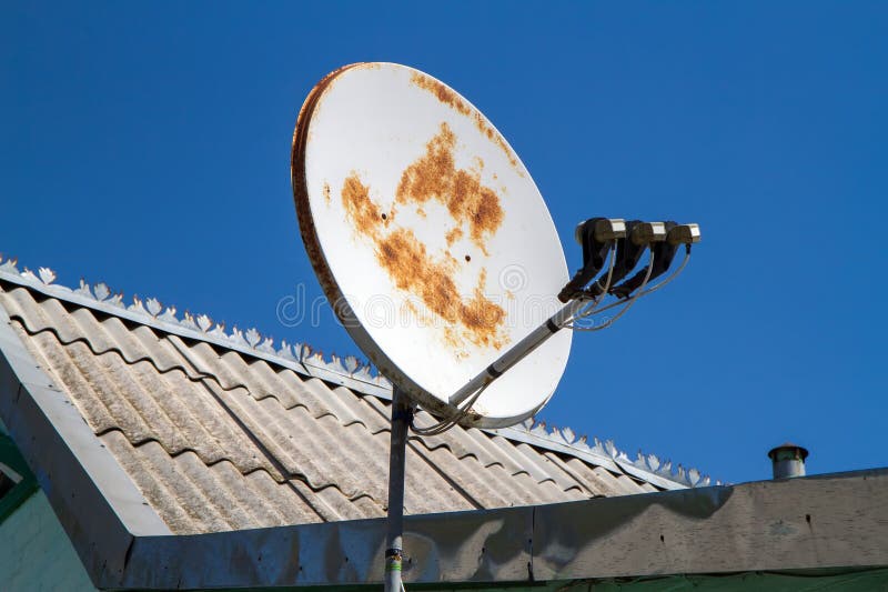 A Rusty Satellite Dish on the Roof of a Private House. Stock Photo ...