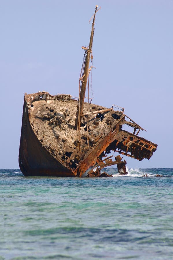 Rusty ship run aground stock photo. Image of cliff, industrial - 22336136