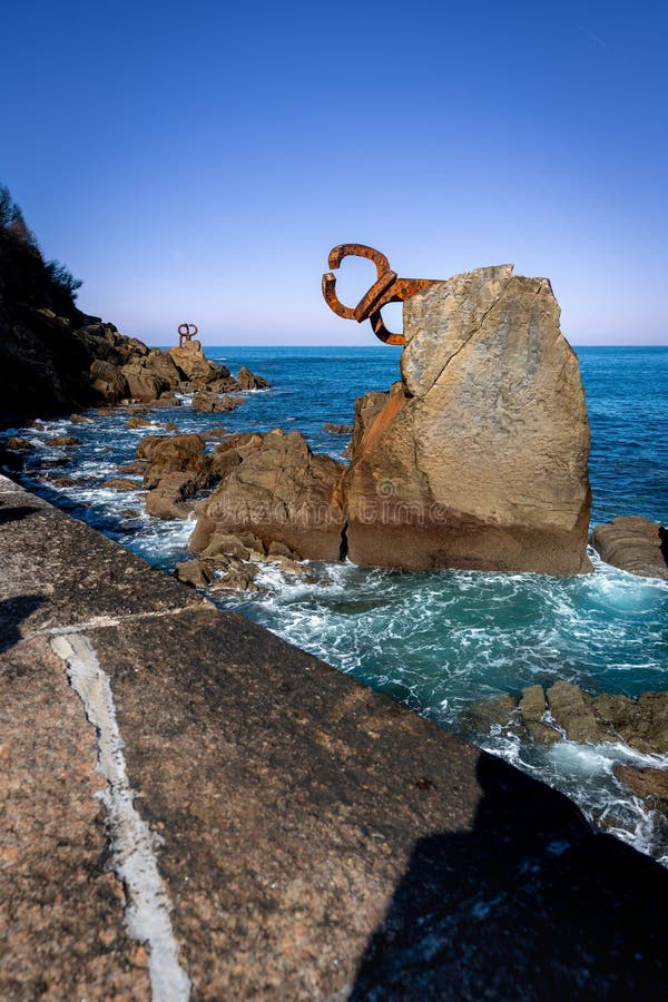 A Sculpture of an Old Rusty Ship Sitting on Top of a Rock Stock Photo ...