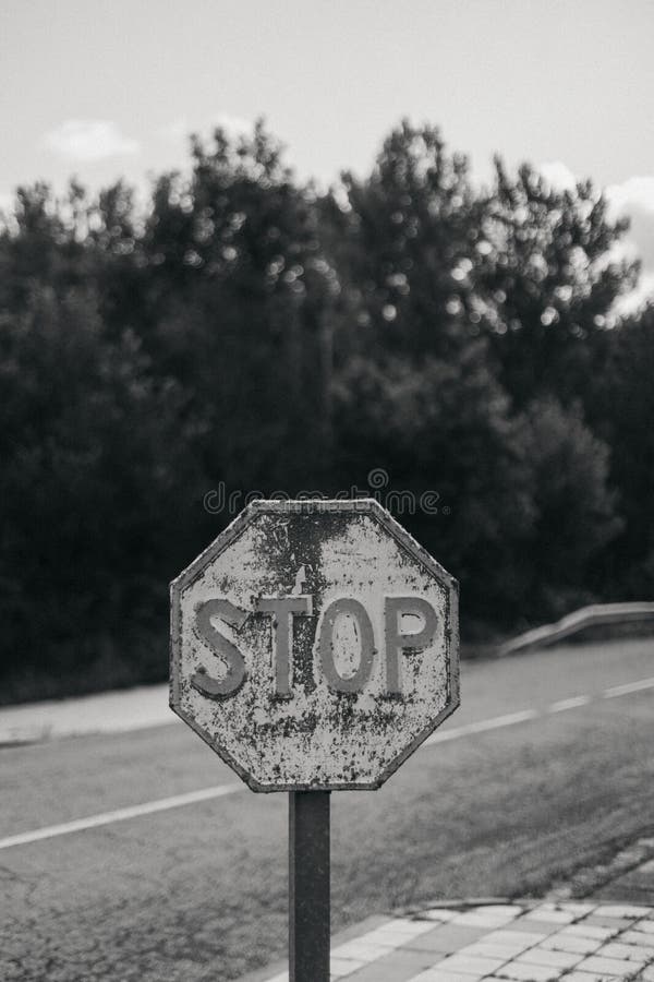 Rusty Stop Sign on the Road in Black and White Stock Photo - Image of ...